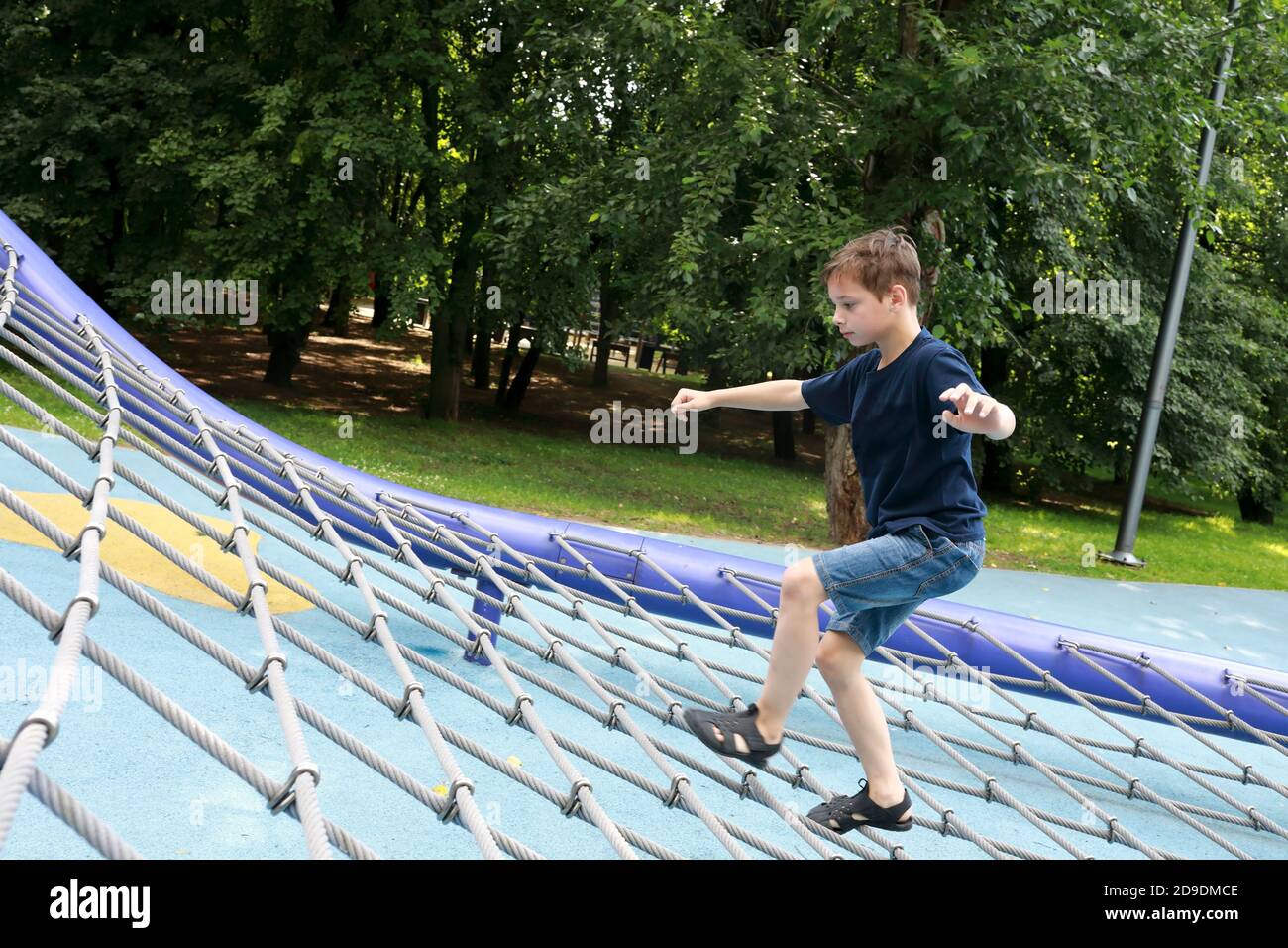 Person climbing over net obstacle hi-res stock photography and images ...