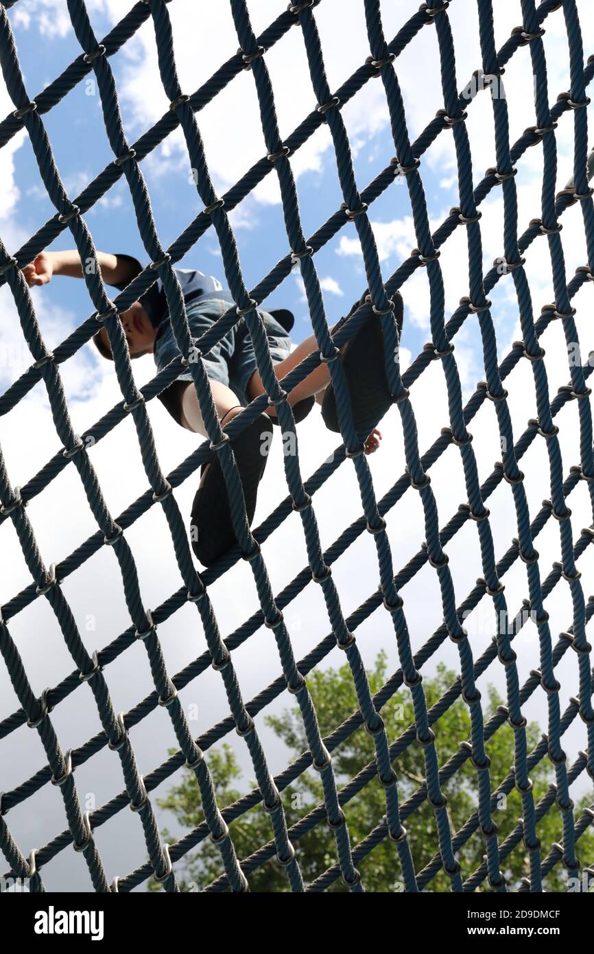 Person climbing over net obstacle hi-res stock photography and images ...