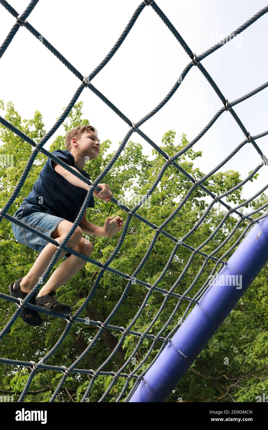 Person climbing over net obstacle hi-res stock photography and images ...