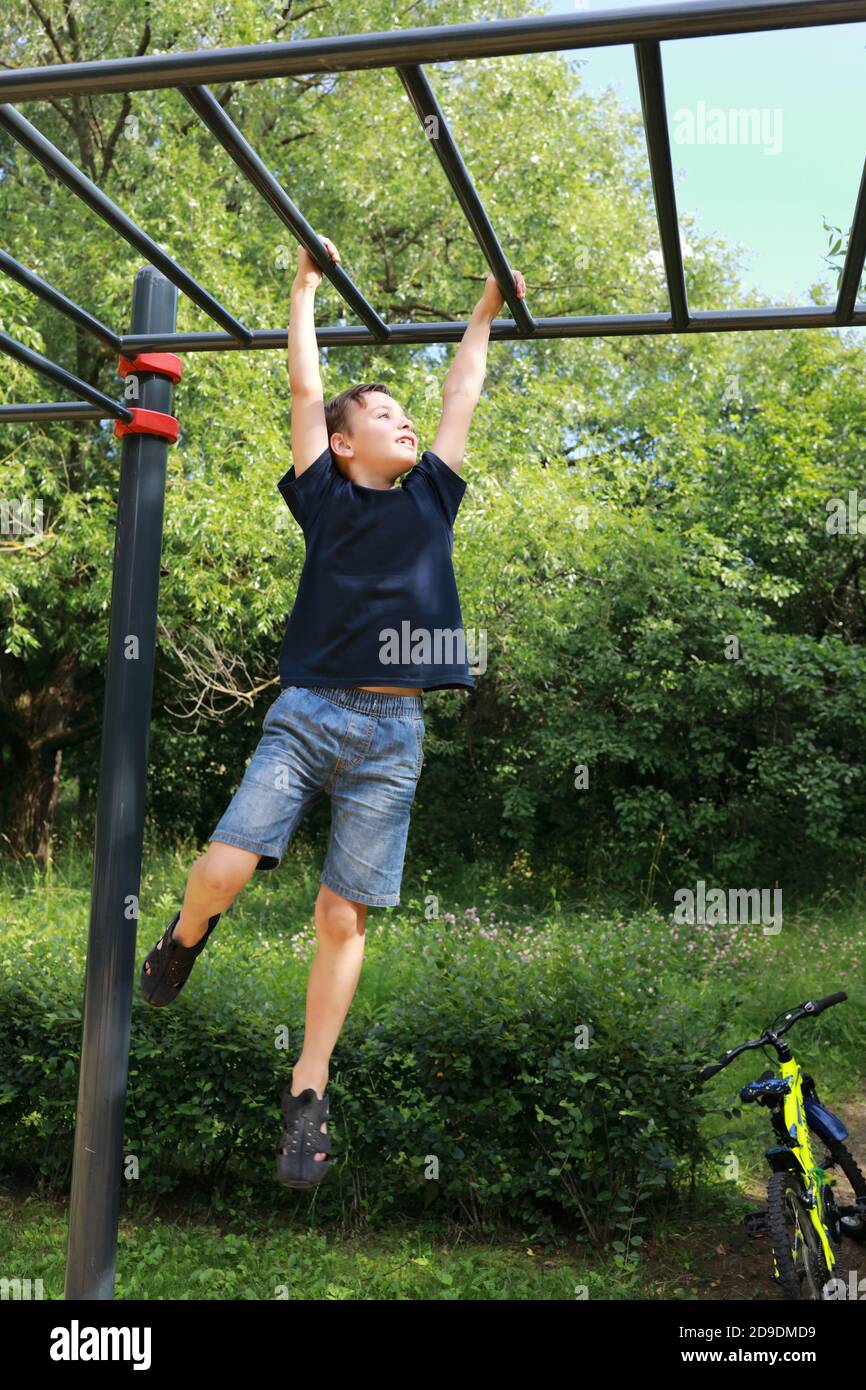 Horizontal bar hanging child hi-res stock photography and images - Alamy