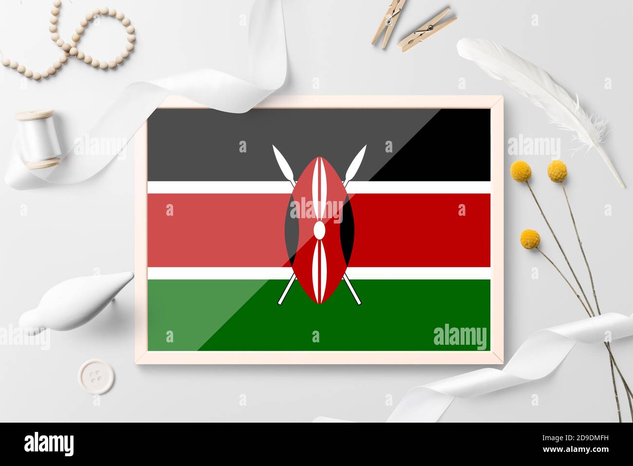 Kenya flag in wooden frame on white creative background. White theme ...