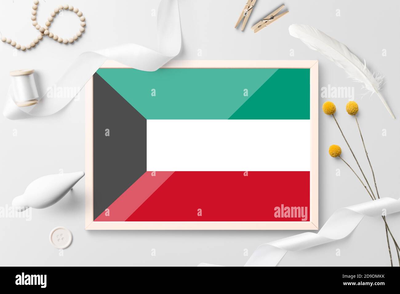 Kuwait flag in wooden frame on white creative background. White theme ...