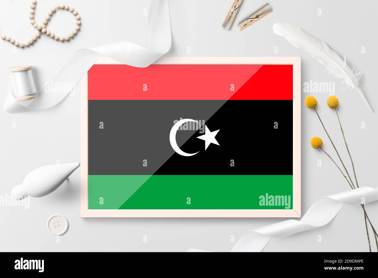 Libya flag in wooden frame on white creative background. White theme ...