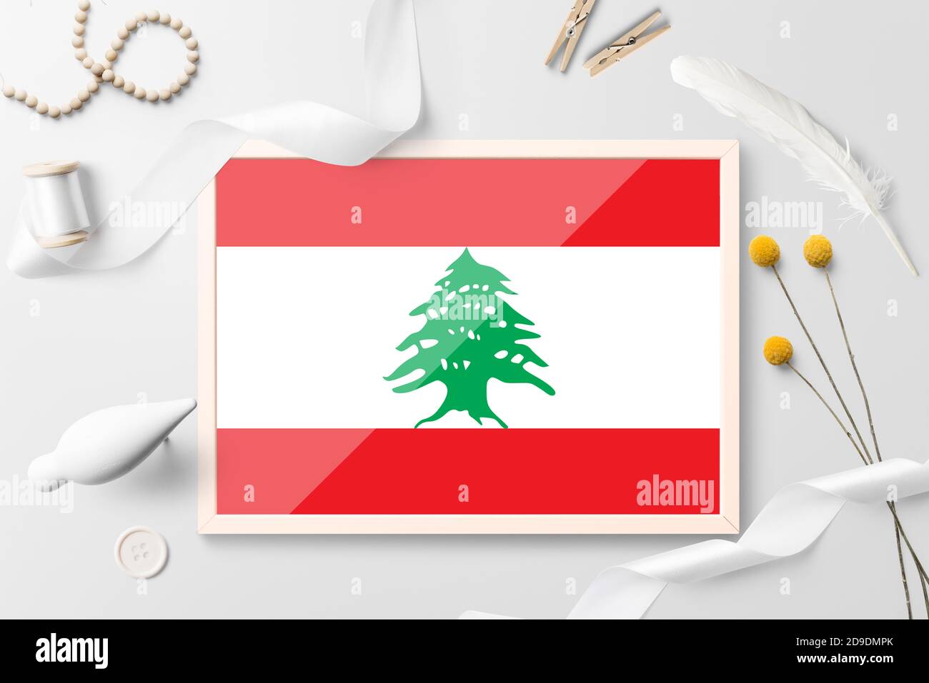 Lebanon flag in wooden frame on white creative background. White theme ...