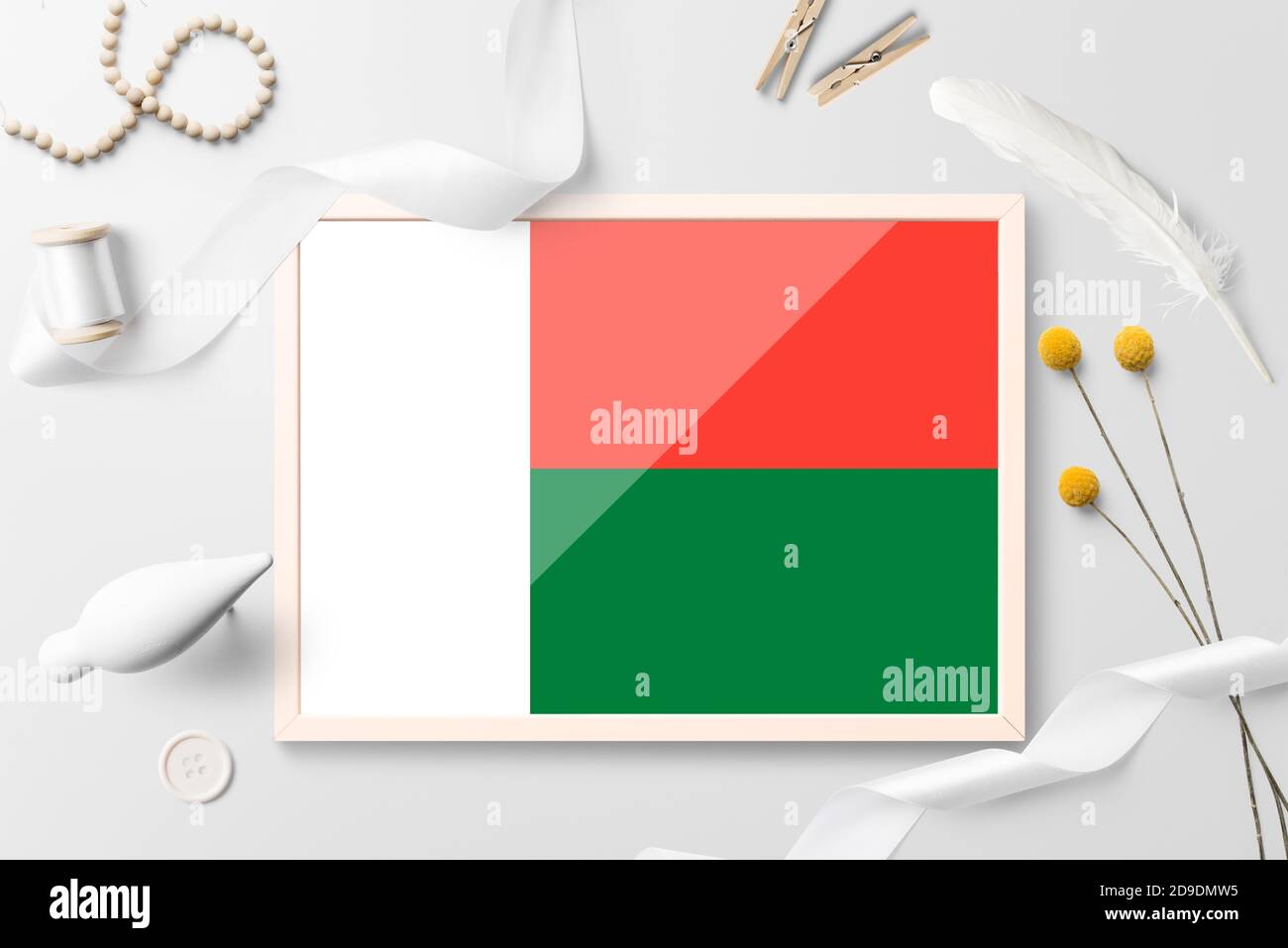 Madagascar flag in wooden frame on white creative background. White ...