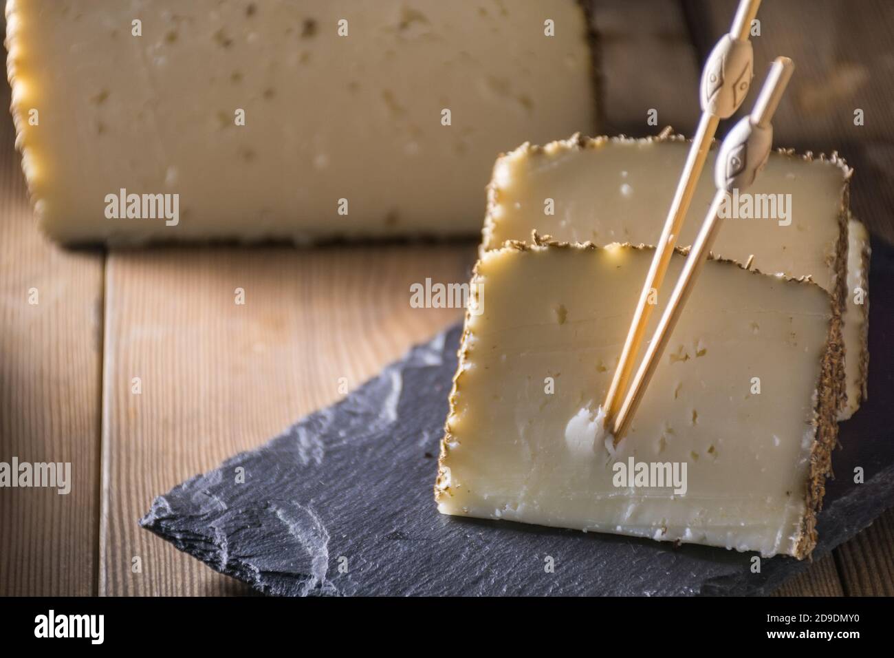 Semi-cured cheese with a thin layer of aromatic herbs. Typical snack of ...