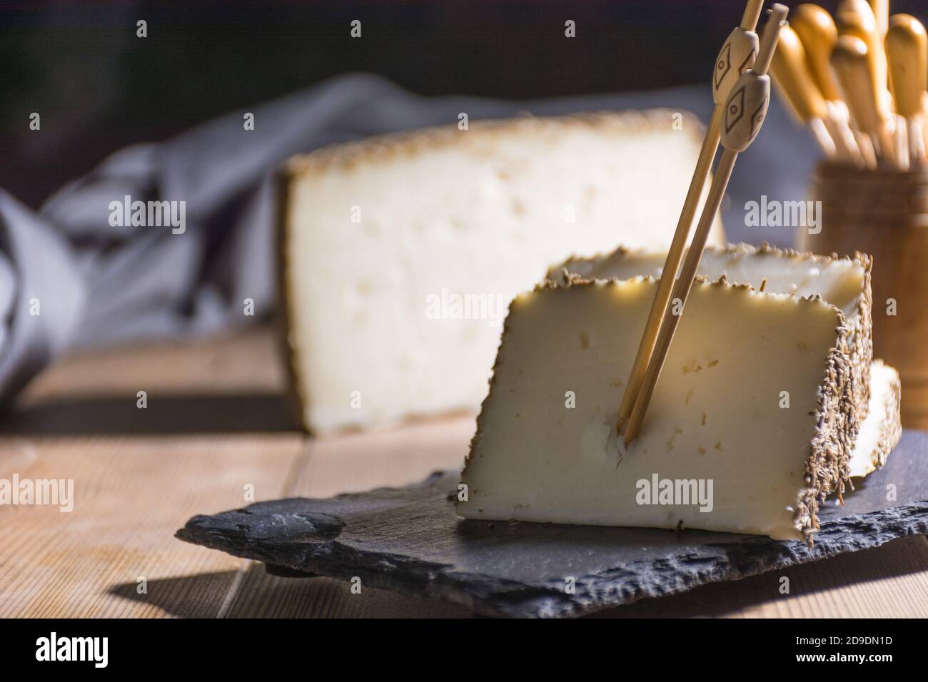 Semi-cured cheese with a thin layer of aromatic herbs. Typical snack of ...