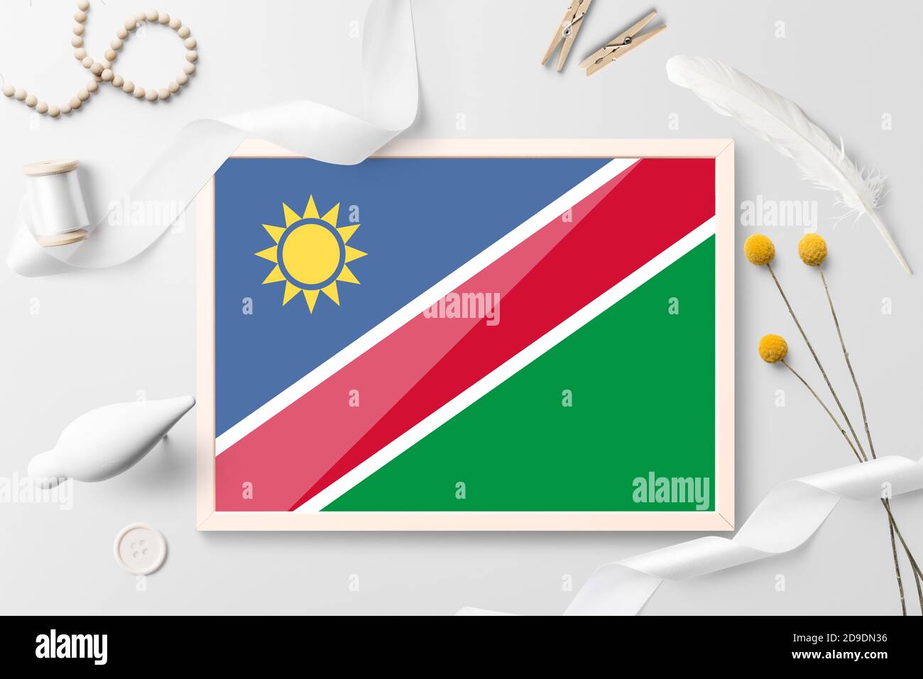 Namibia flag in wooden frame on white creative background. White theme ...