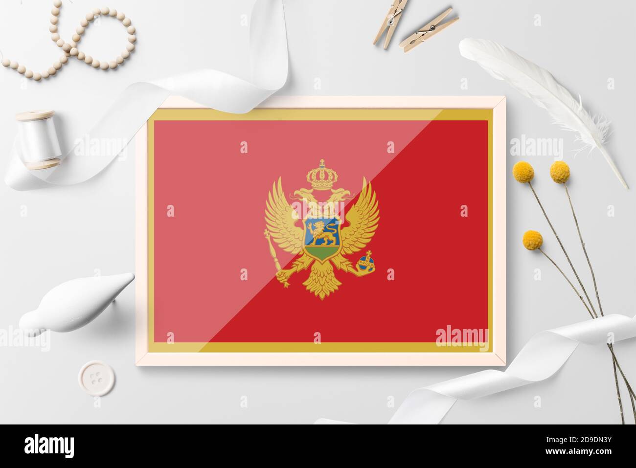 Montenegro flag in wooden frame on white creative background. White ...
