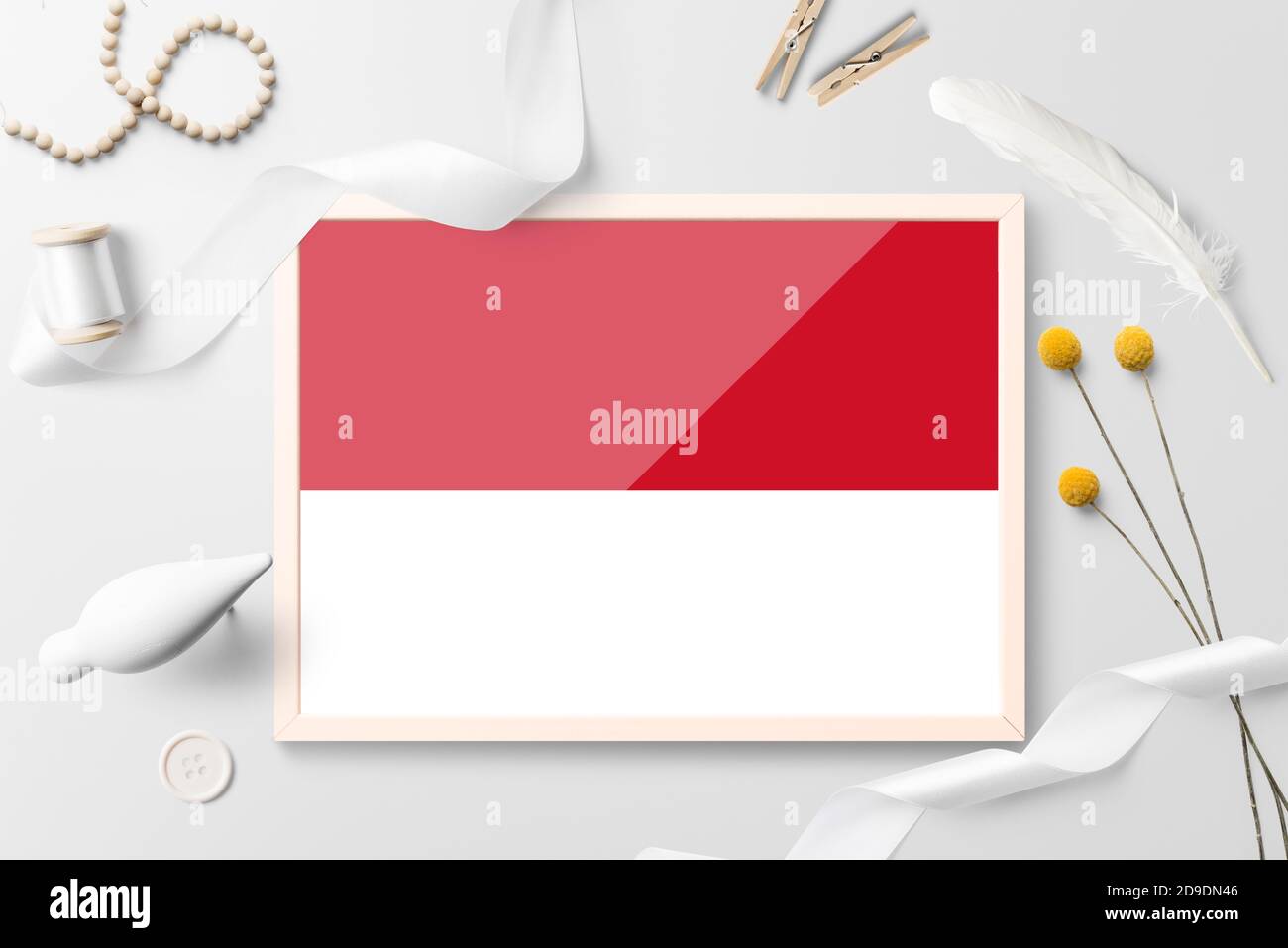 Monaco flag in wooden frame on white creative background. White theme ...