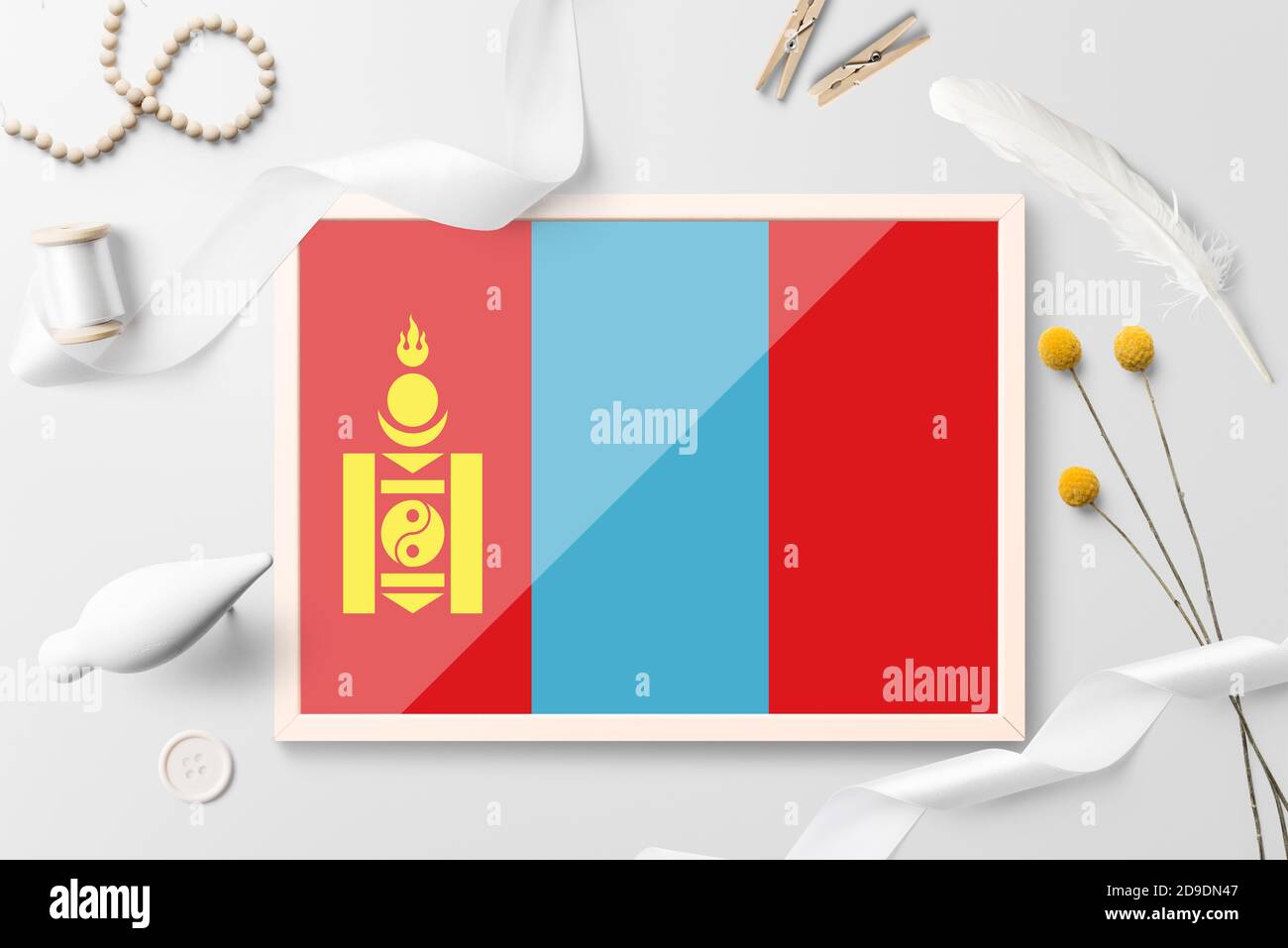 Mongolia flag in wooden frame on white creative background. White theme ...