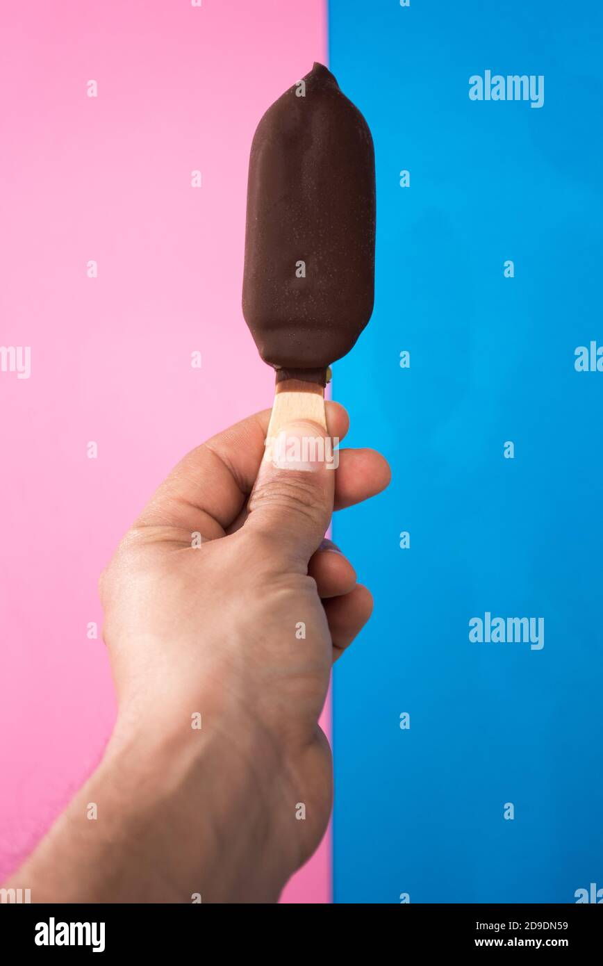 hand holding a chocolate and mint ice cream, with two colors, blue and ...