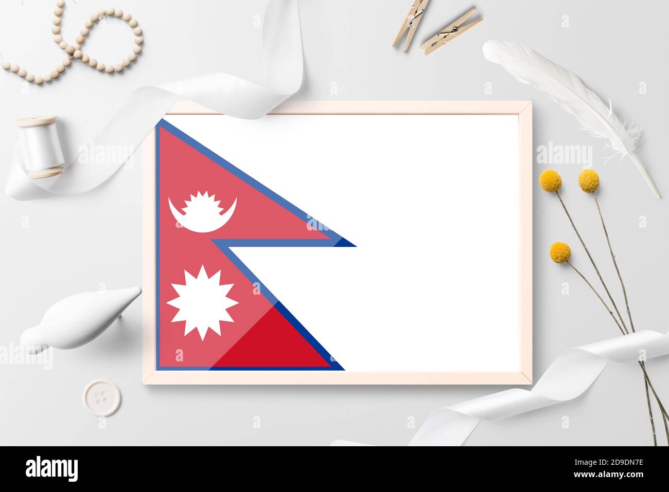 Nepal flag in wooden frame on white creative background. White theme ...