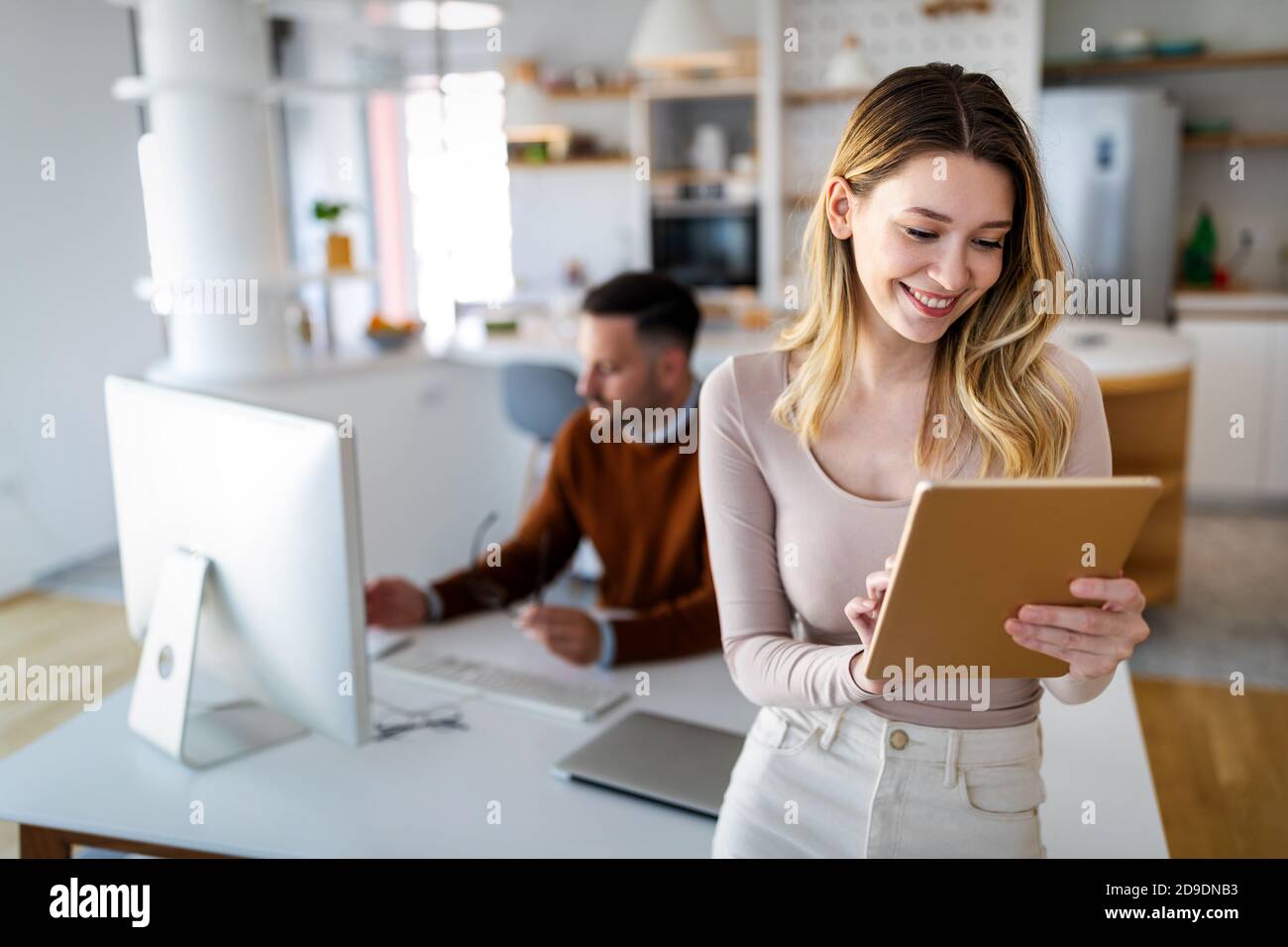 Positive couple having fun while working together remotely at home ...