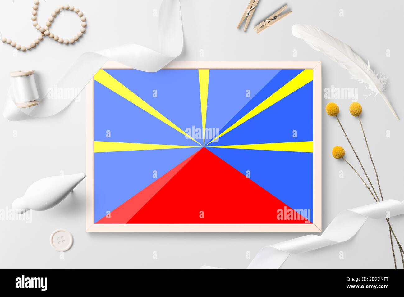Reunion flag in wooden frame on white creative background. White theme ...