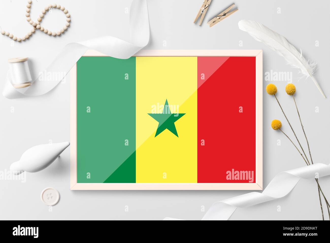 Senegal flag in wooden frame on white creative background. White theme ...