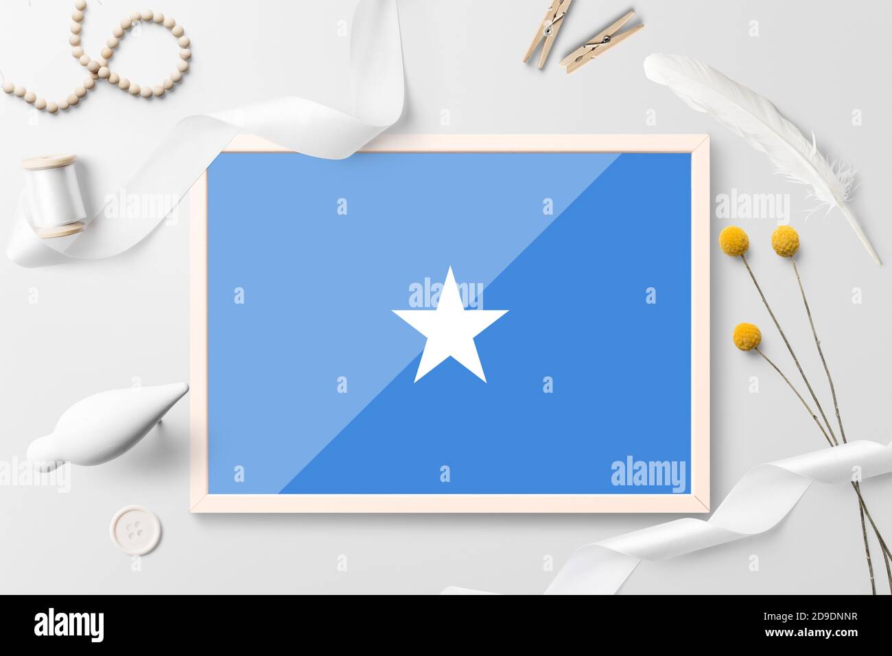 Somalia flag in wooden frame on white creative background. White theme ...