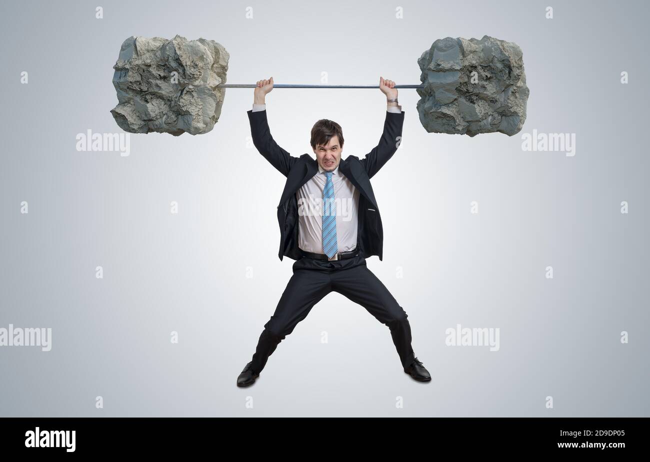 Young businessman in suit is lifting heavy weights Stock Photo - Alamy