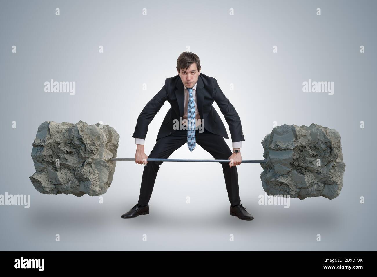 Young businessman in suit is lifting heavy weights Stock Photo - Alamy