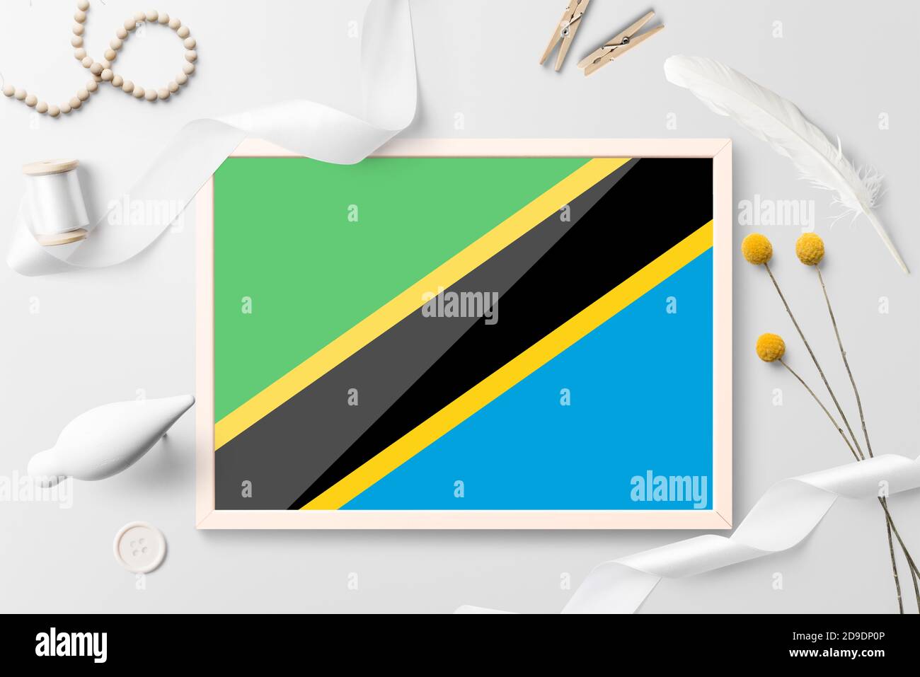 Tanzania flag in wooden frame on white creative background. White theme ...
