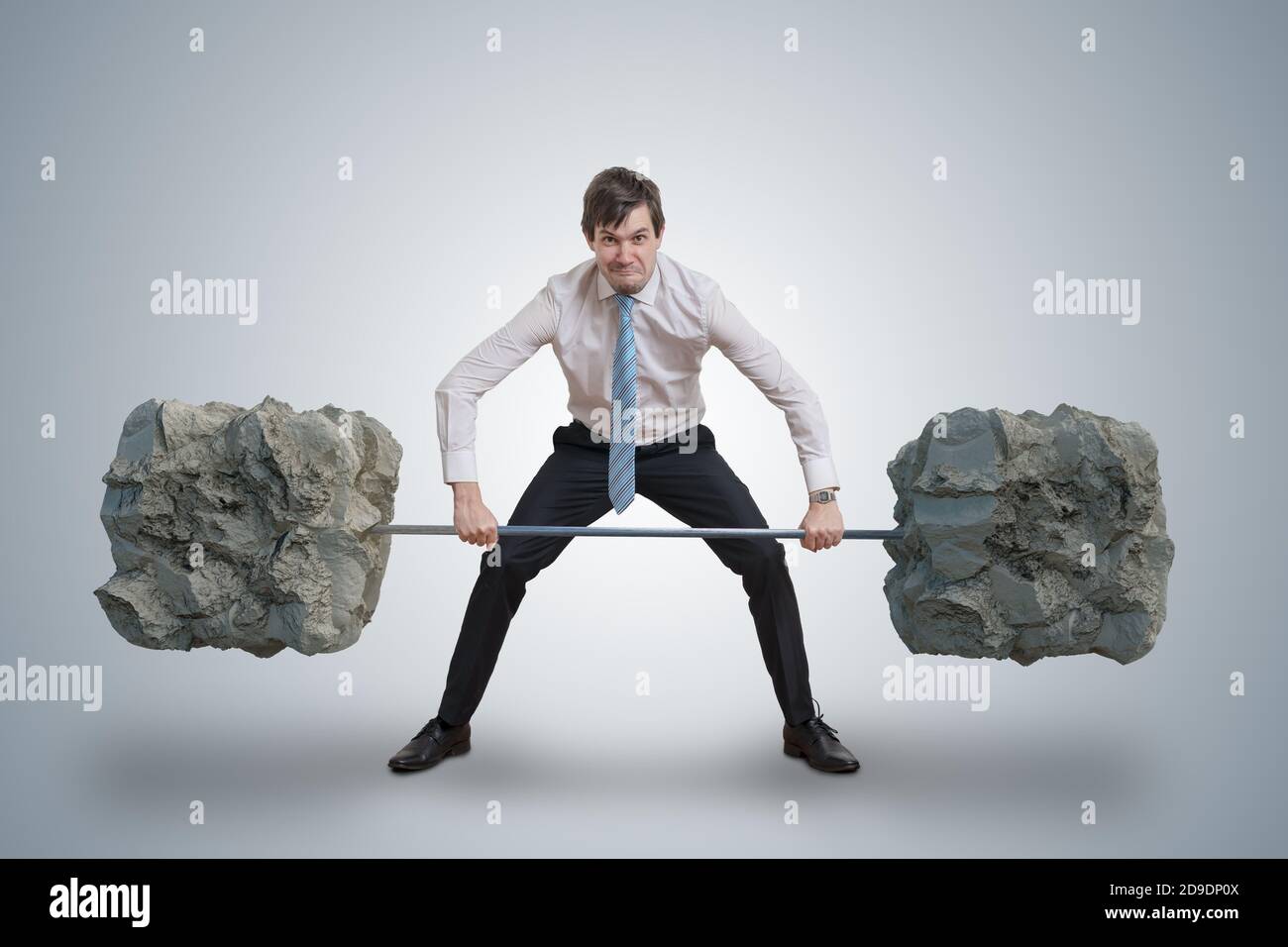 Businessman lifting rock hi-res stock photography and images - Alamy