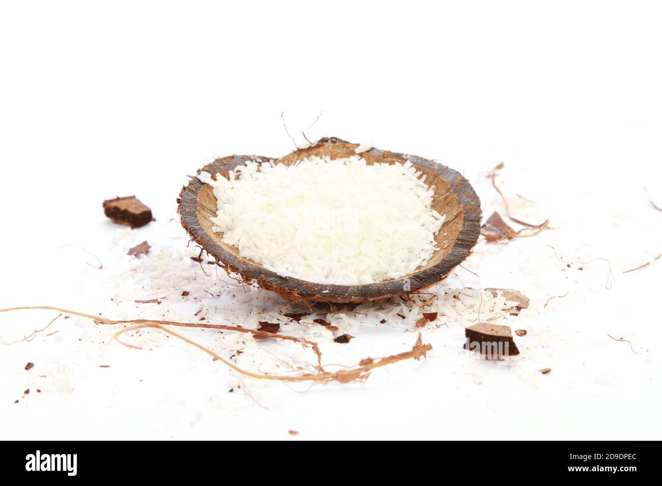 Broken coconut shell with coconut shavings isolated on a white ...