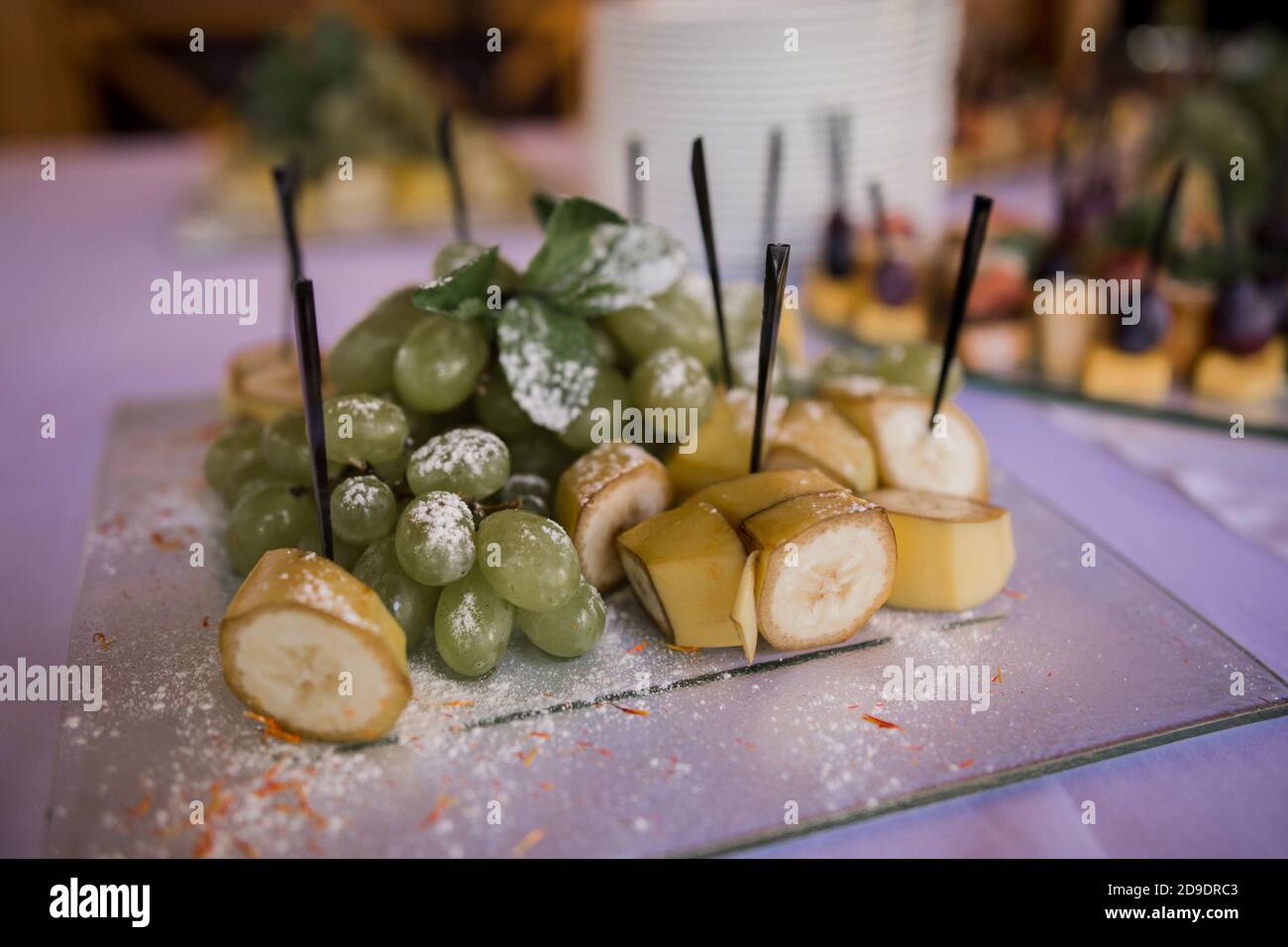 bananas and grapes on a buffet table in restaurant Stock Photo - Alamy