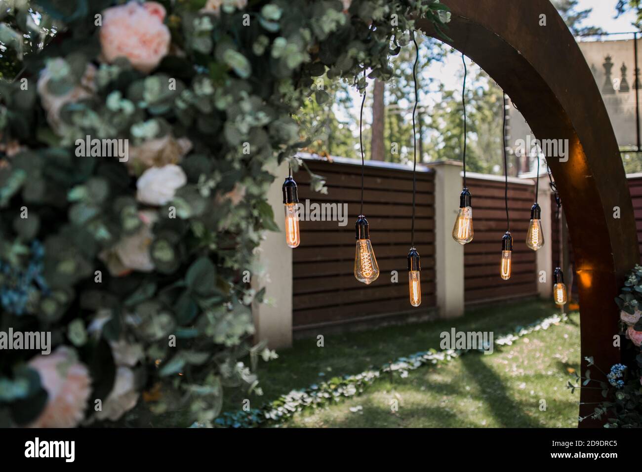 a light bulbs on round wedding arch for ceremony Stock Photo - Alamy