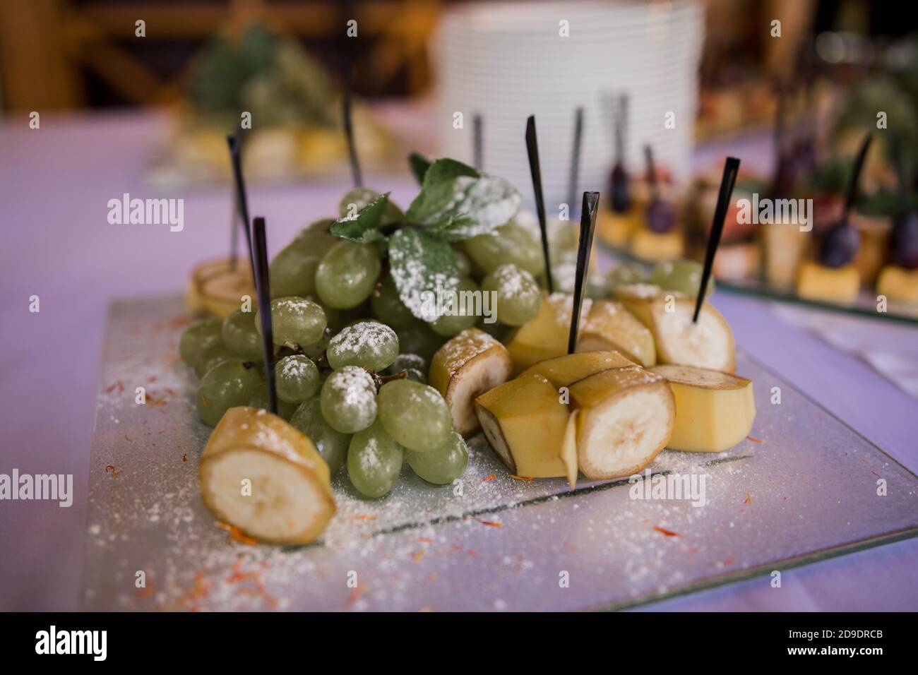 bananas and grapes on a buffet table in restaurant Stock Photo - Alamy