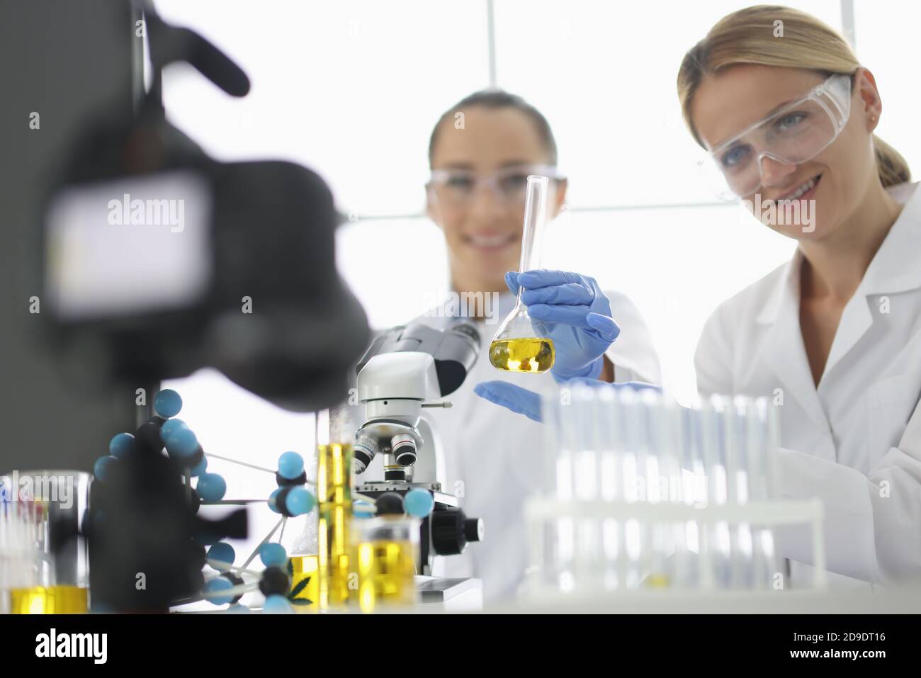 Two researchers are filming experiments in laboratory on camera Stock ...