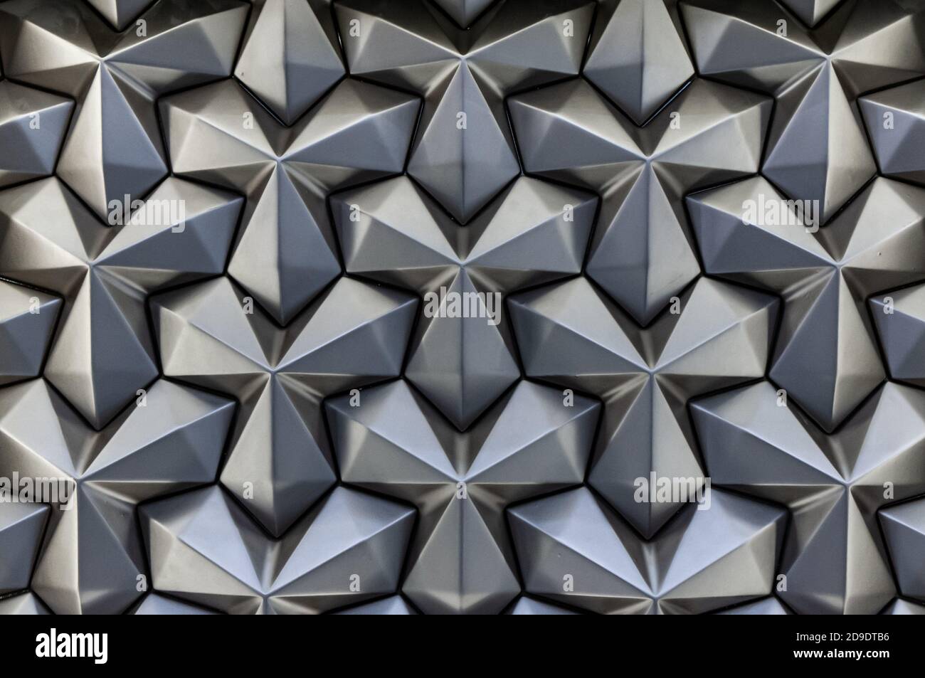 Abstract silver metal background. Geometric metal pattern angular cladding Stock Photo - Alamy