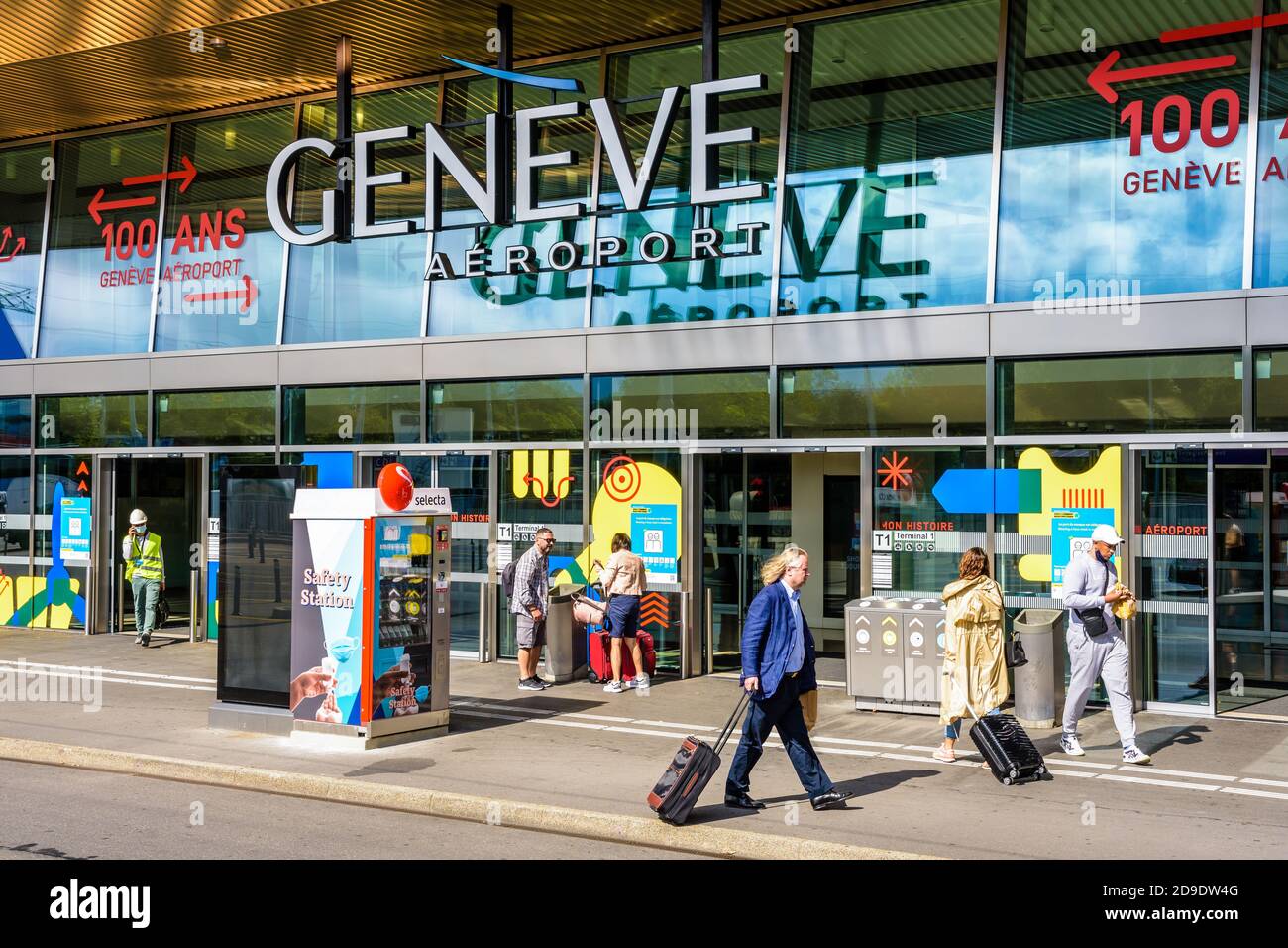 Passengers waiting or walking in front of the entrance of the ...