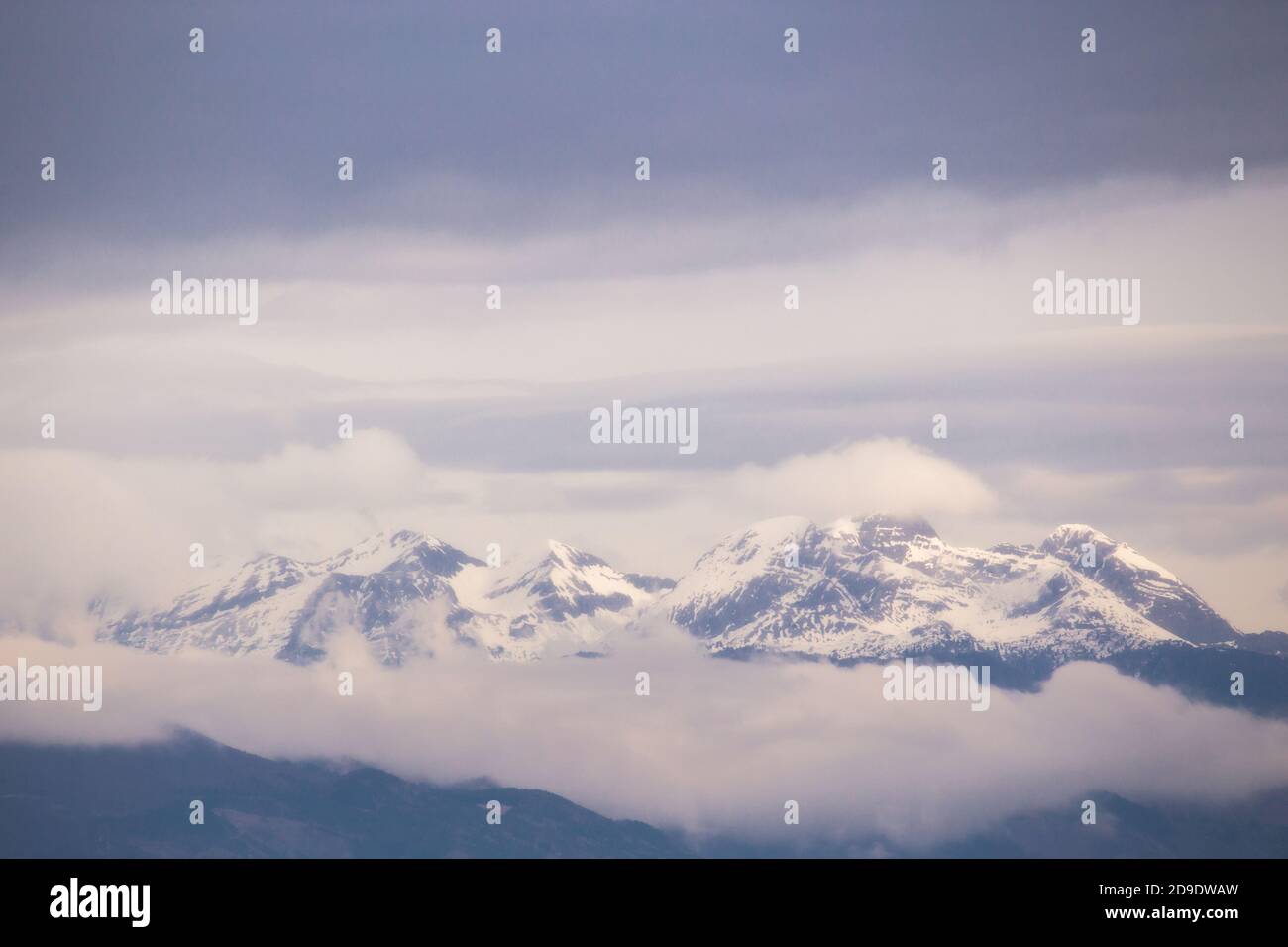 Snowy mountains emerging from the clouds Stock Photo - Alamy