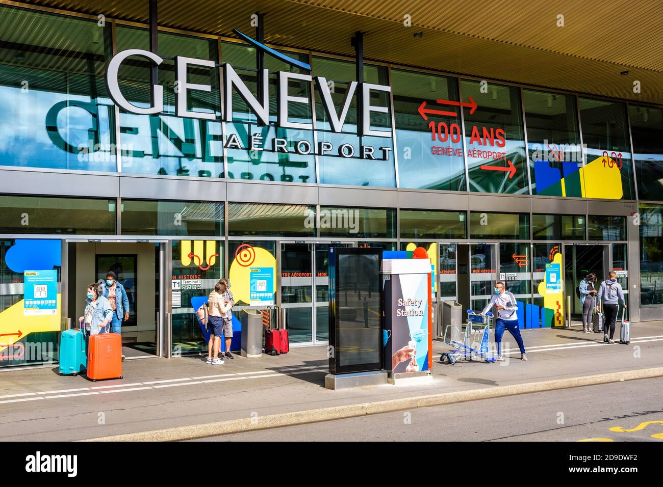 Passengers waiting or walking in front of the entrance of the ...