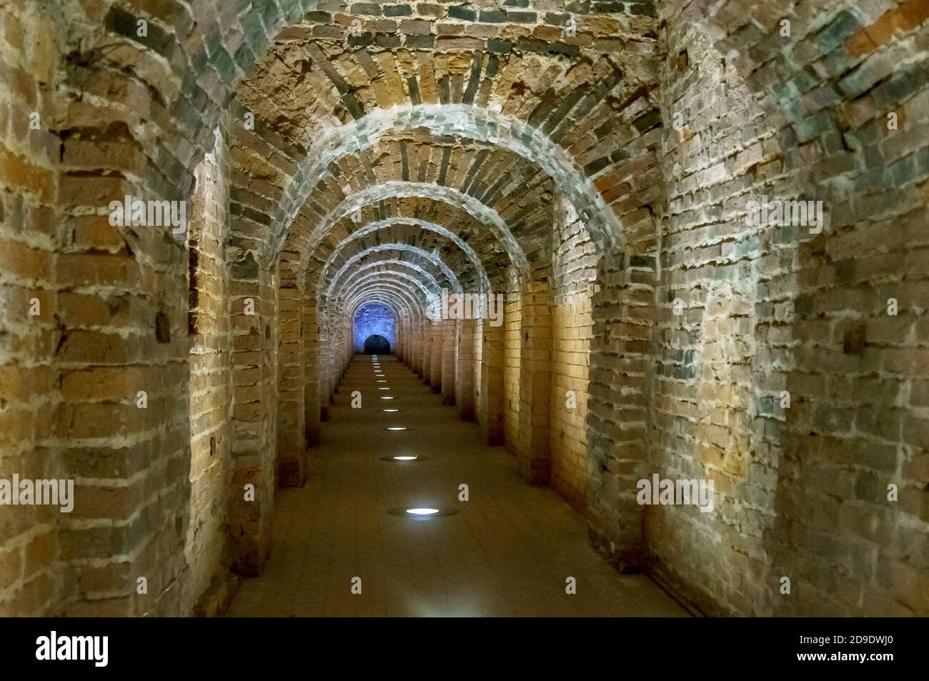 Brick archway made of red bricks as a passage between the two wings of ...