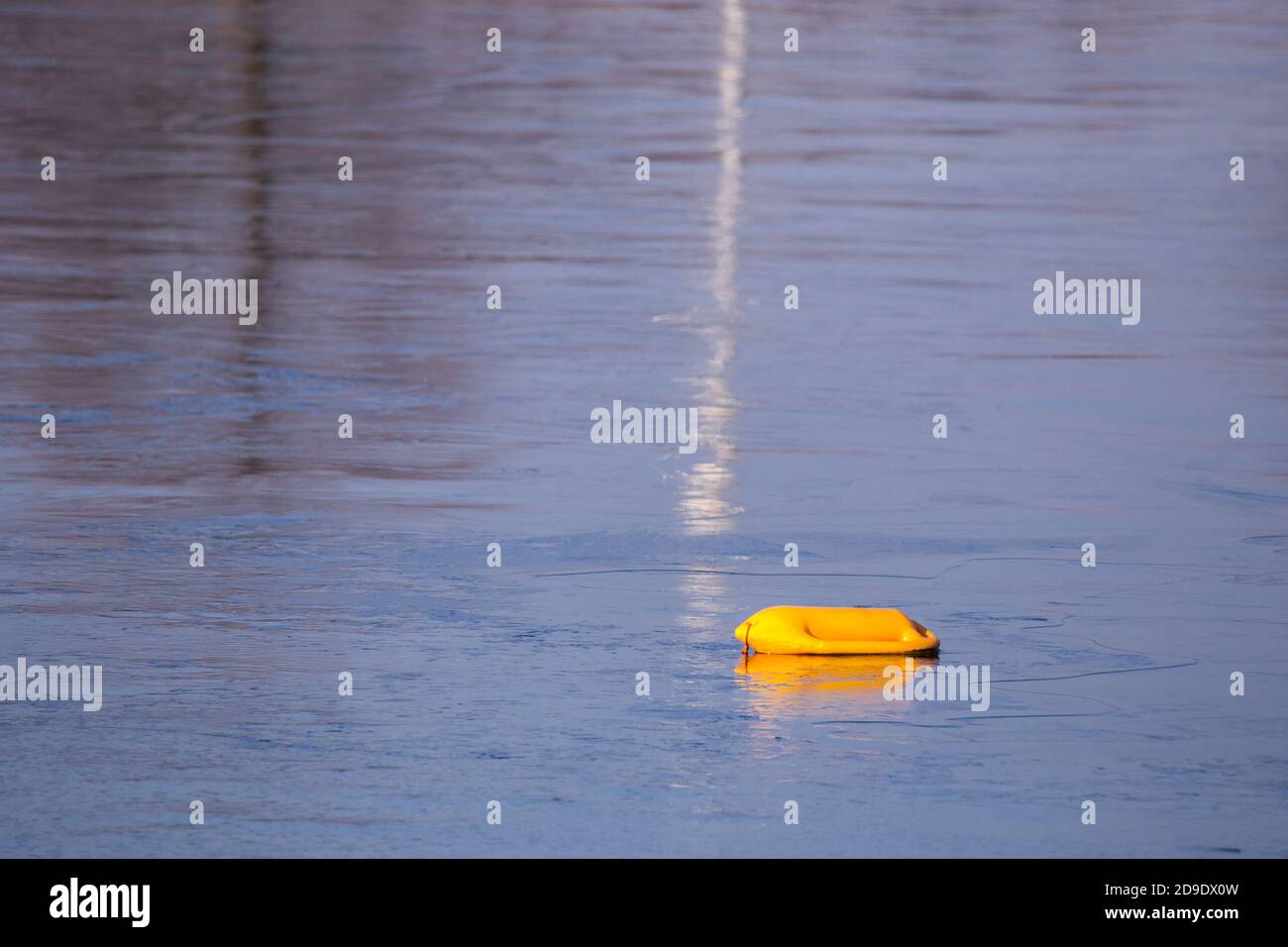 Life buoy floating on a frozen water Stock Photo - Alamy
