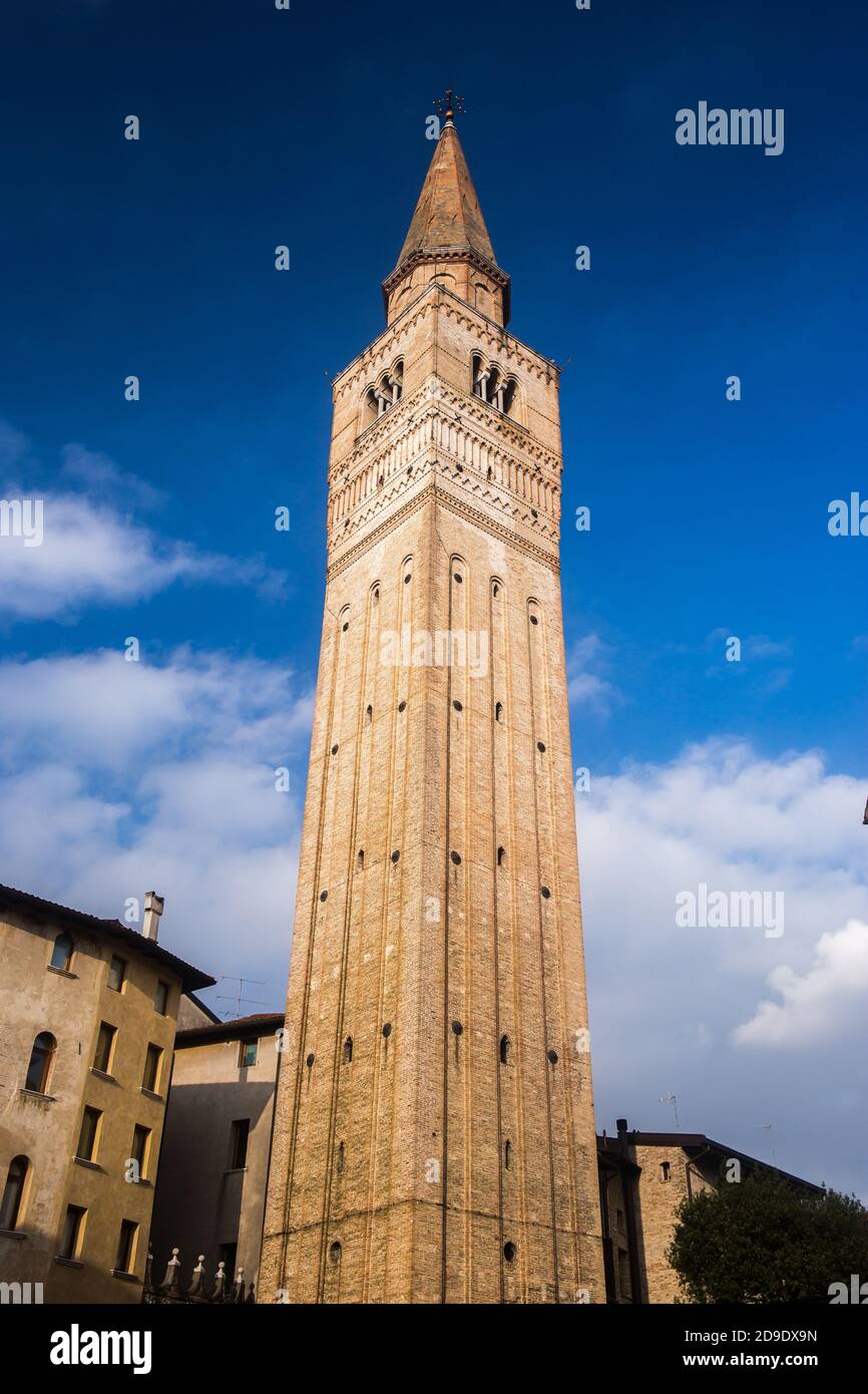 Tall stone historic bell tower stretching to the sky in city center ...