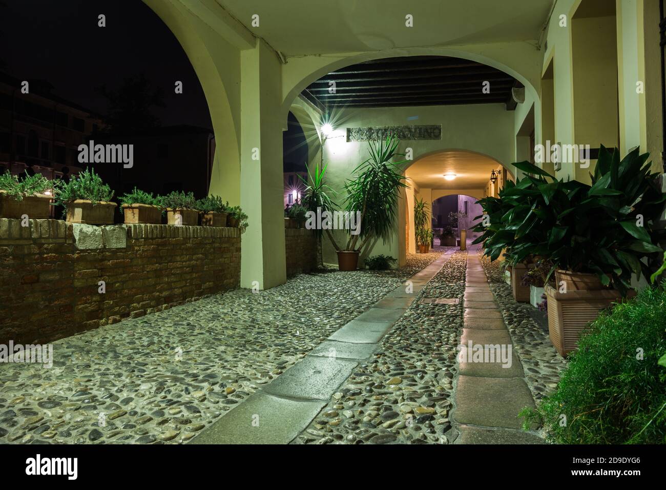 Ancient stone passage in city center on the Buranelli canal at night ...