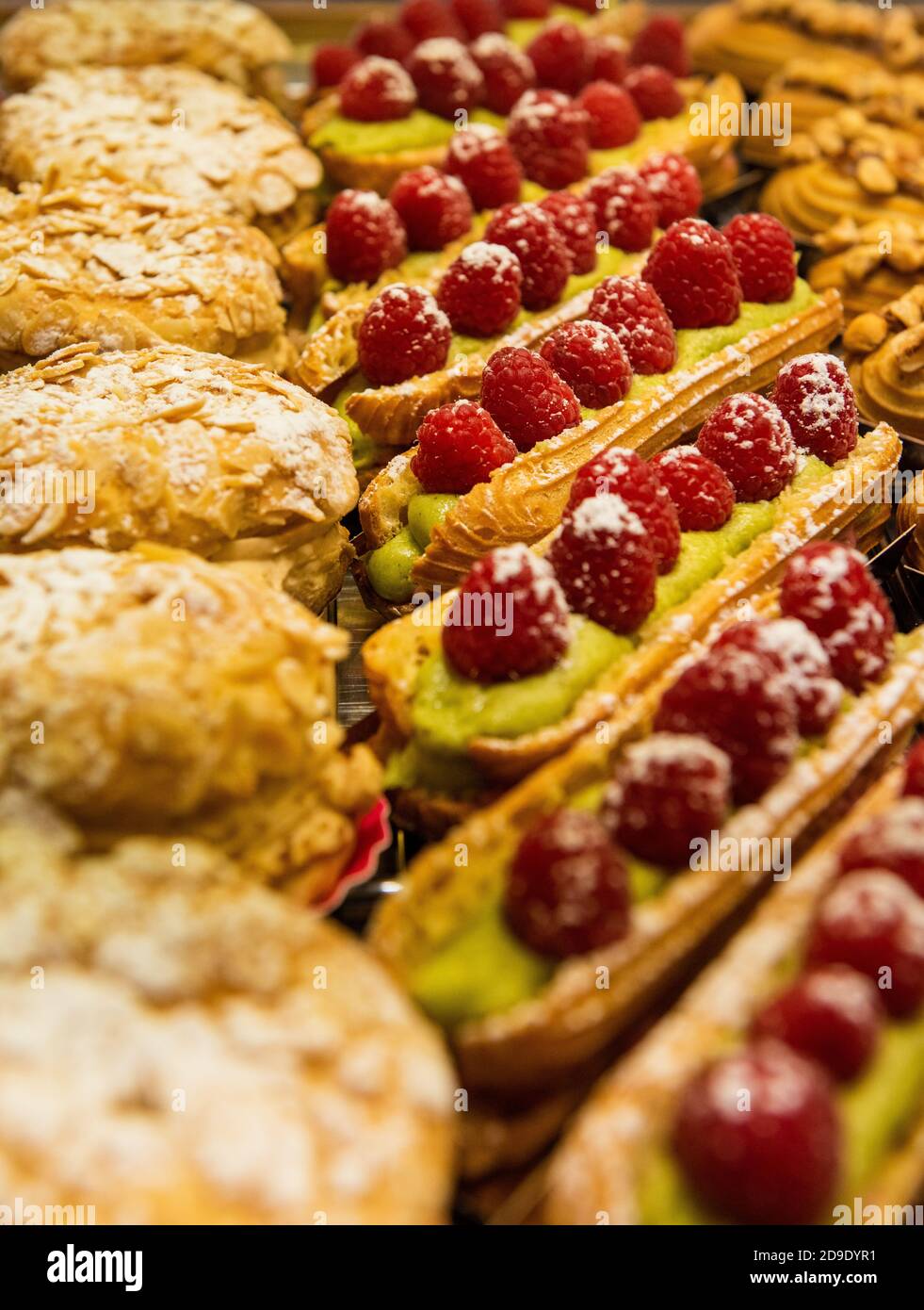 Close up French pastry eclairs with raspberry Stock Photo - Alamy