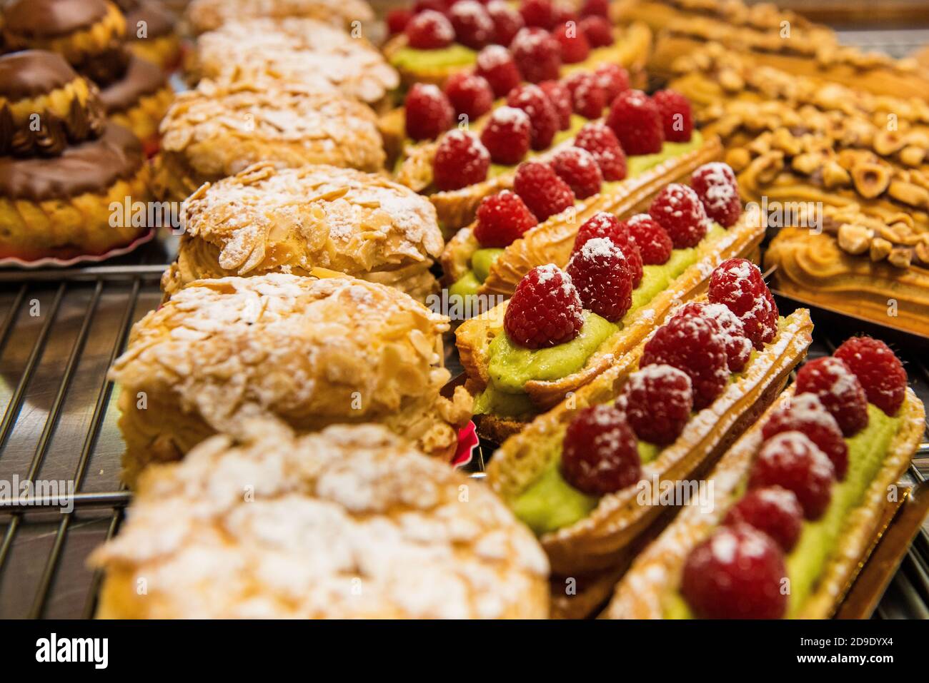 Close up French pastry eclairs with raspberry and almond nuts Stock ...