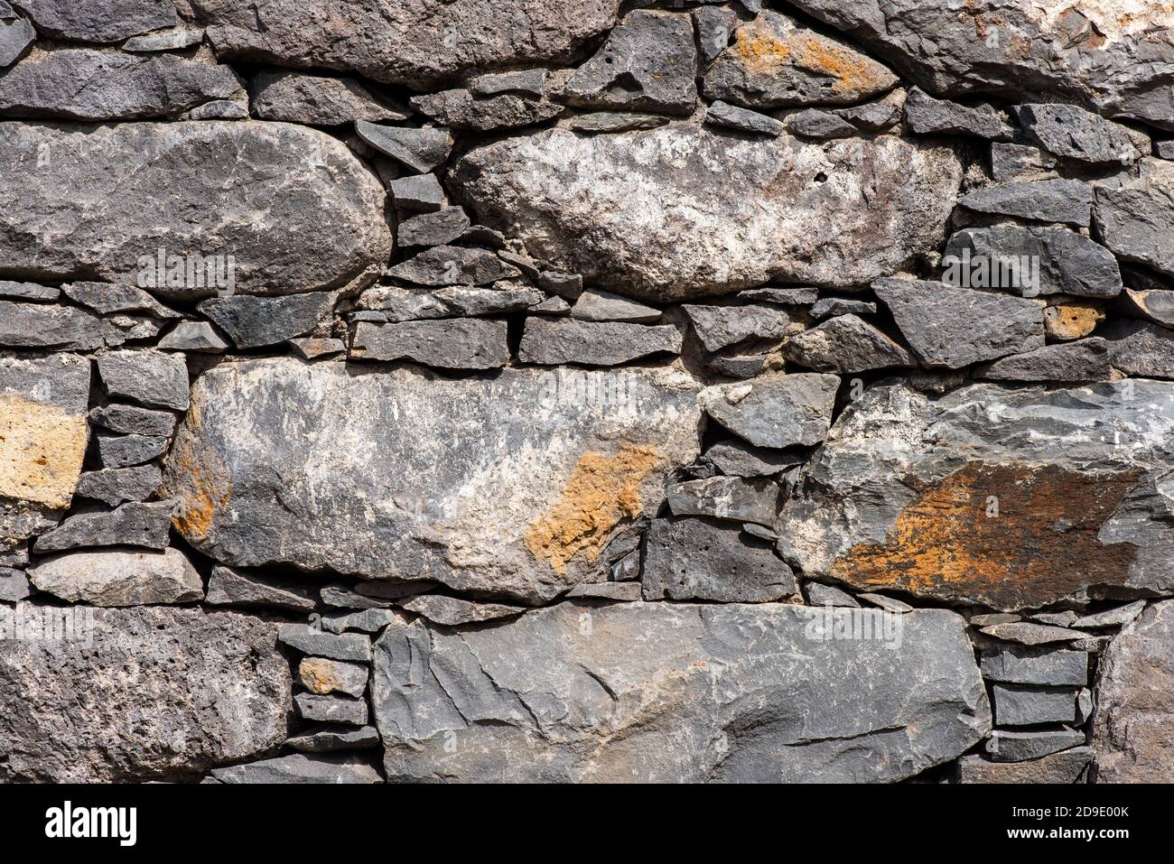 Basalt stone wall with big and small rocks Stock Photo - Alamy