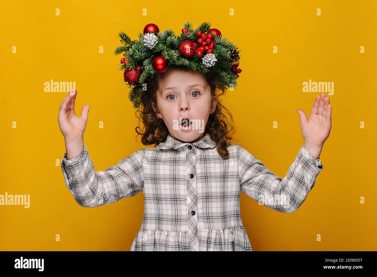Shocked cute little kid girl showing big size gesture with hands ...