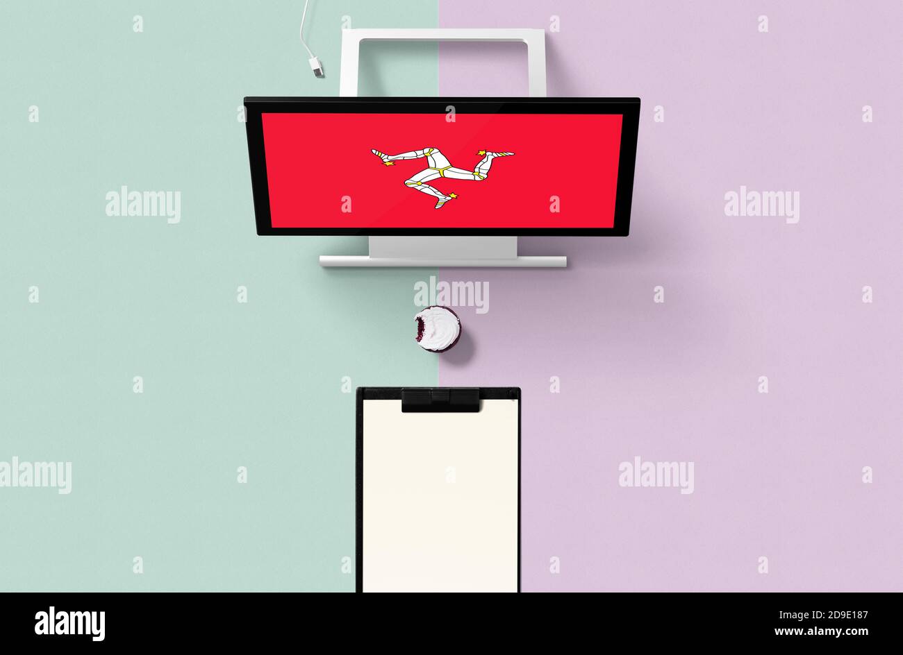 Isle Of Man national flag on computer screen top view, cupcake and ...