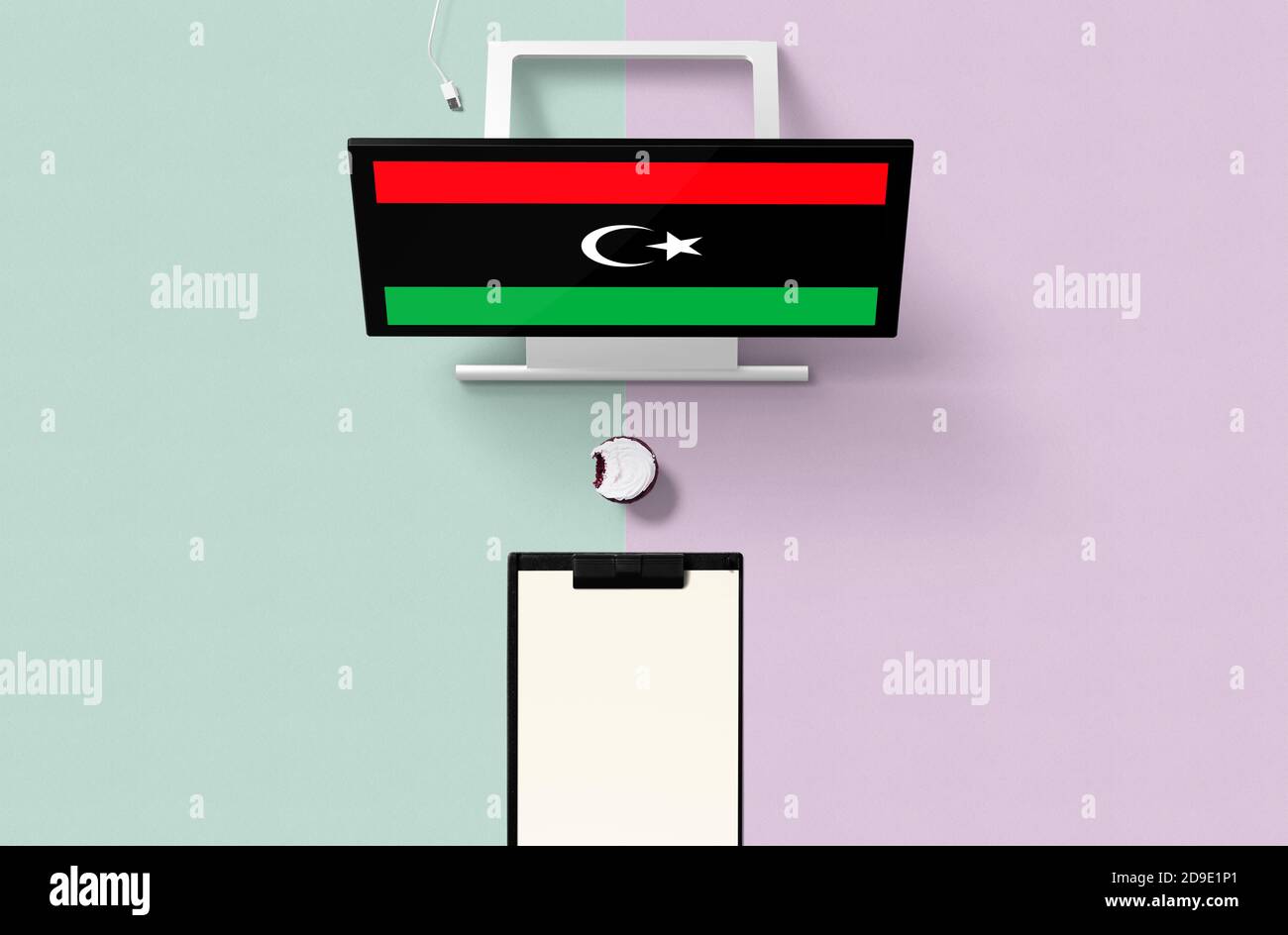 Libya national flag on computer screen top view, cupcake and empty note ...