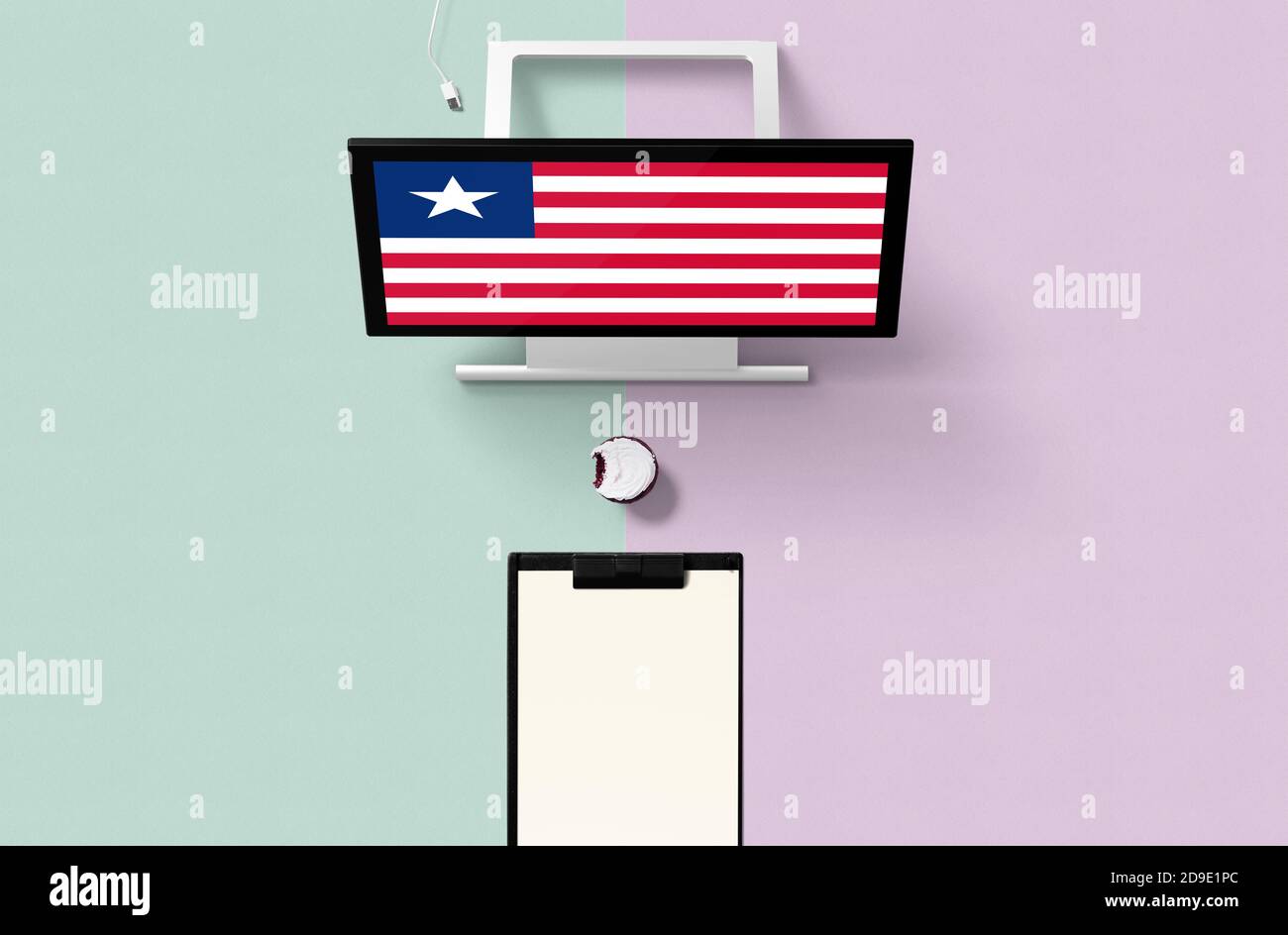 Liberia national flag on computer screen top view, cupcake and empty ...