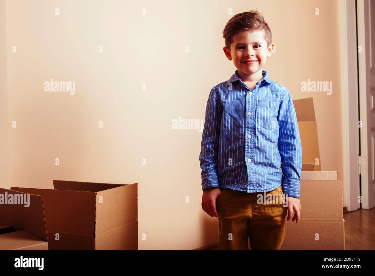 little cute boy in empty room, move to new house. home alone among ...