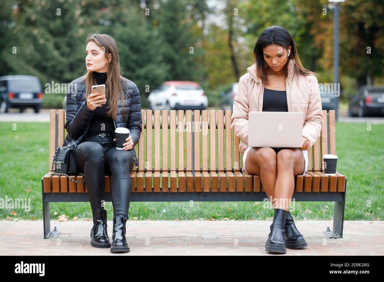 Two young women sitting park studying hi-res stock photography and ...