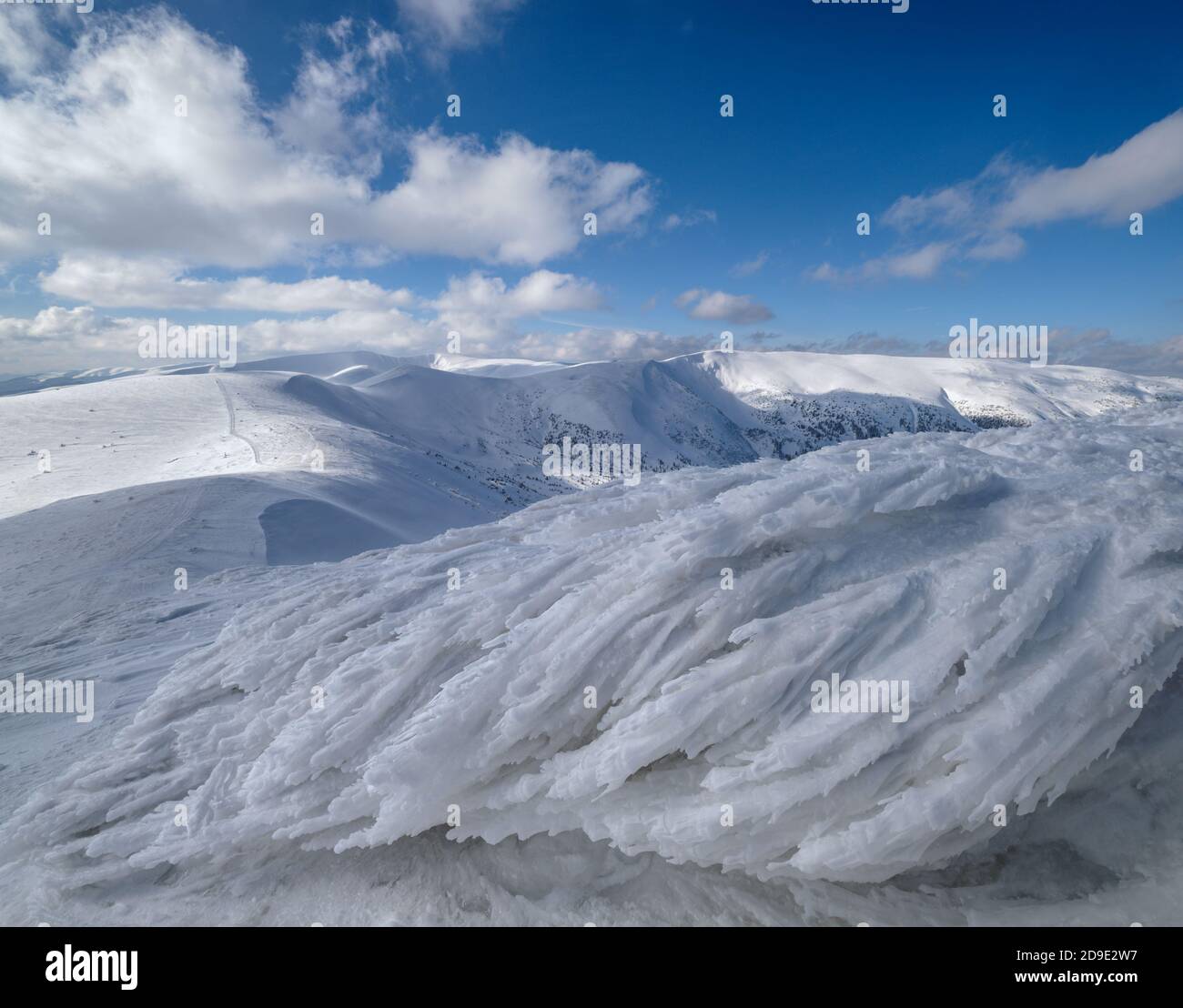 Snow and wind formed ice formations covered winter mountain plateau ...