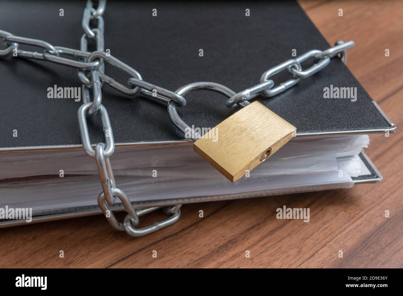 Confidential files and documents in binder locked with padlock and ...