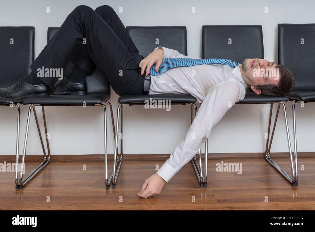 Man sleeping in waiting room hi-res stock photography and images - Alamy